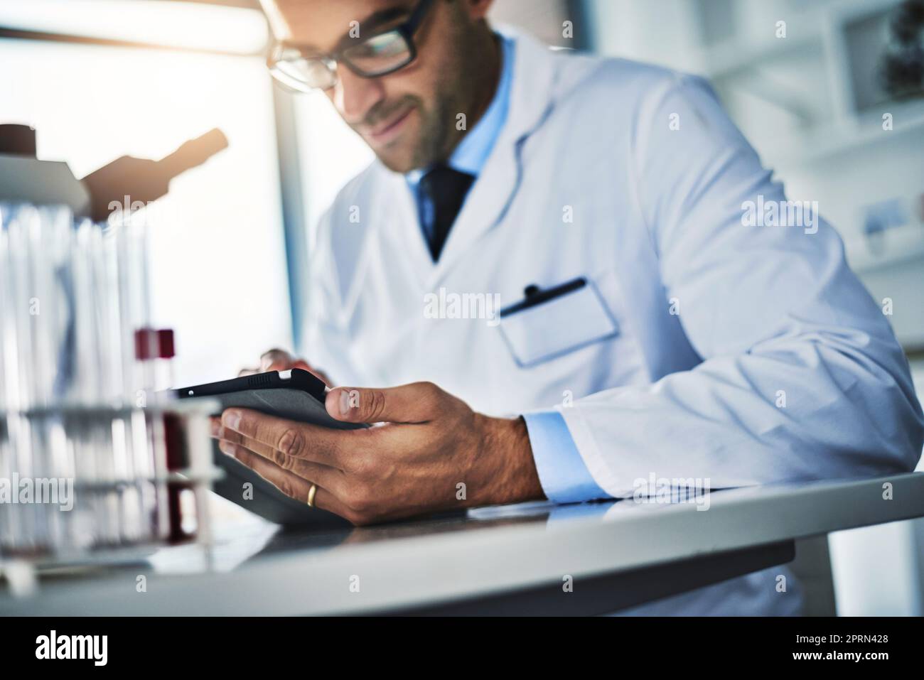 He only uses smart tools in his lab. a scientist using a digital tablet ...