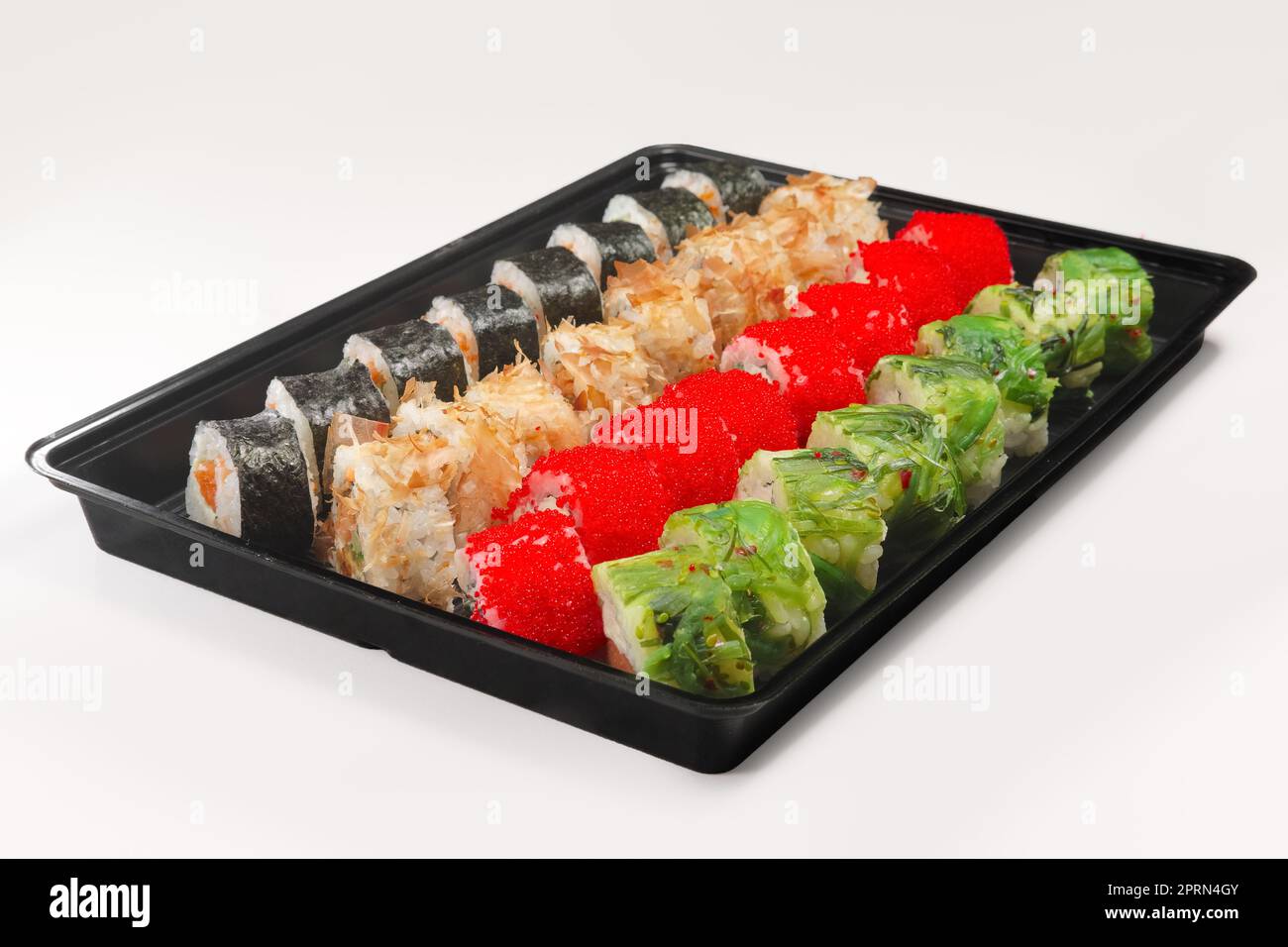 Plastic tray with set of rolls with smoked salmon, eel, chuka salad and ...