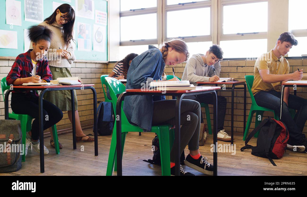 Youre doing really well keep going. a cheerful young teacher giving ...