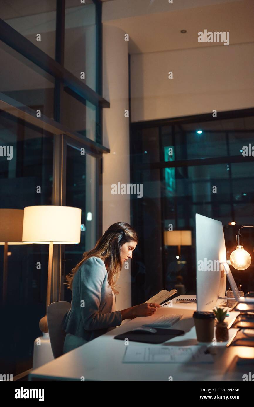 All night dedication, all night productivity. a young businesswoman ...