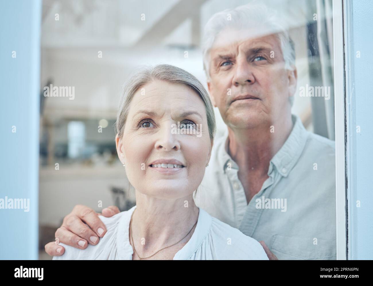 Family, couple and senior people at a window for looking, talking and ...