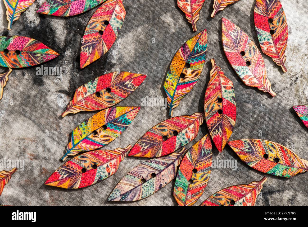 Colorful ornamental button with leave form on the white and gray ...