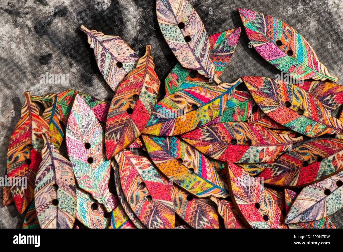 Colorful ornamental button with leave form on the white and gray ...