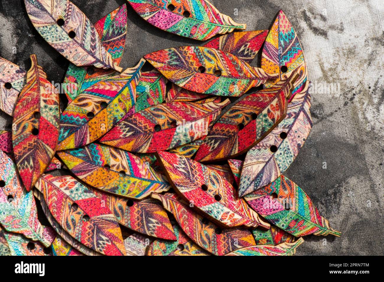 Colorful ornamental button with leave form on the white and gray ...