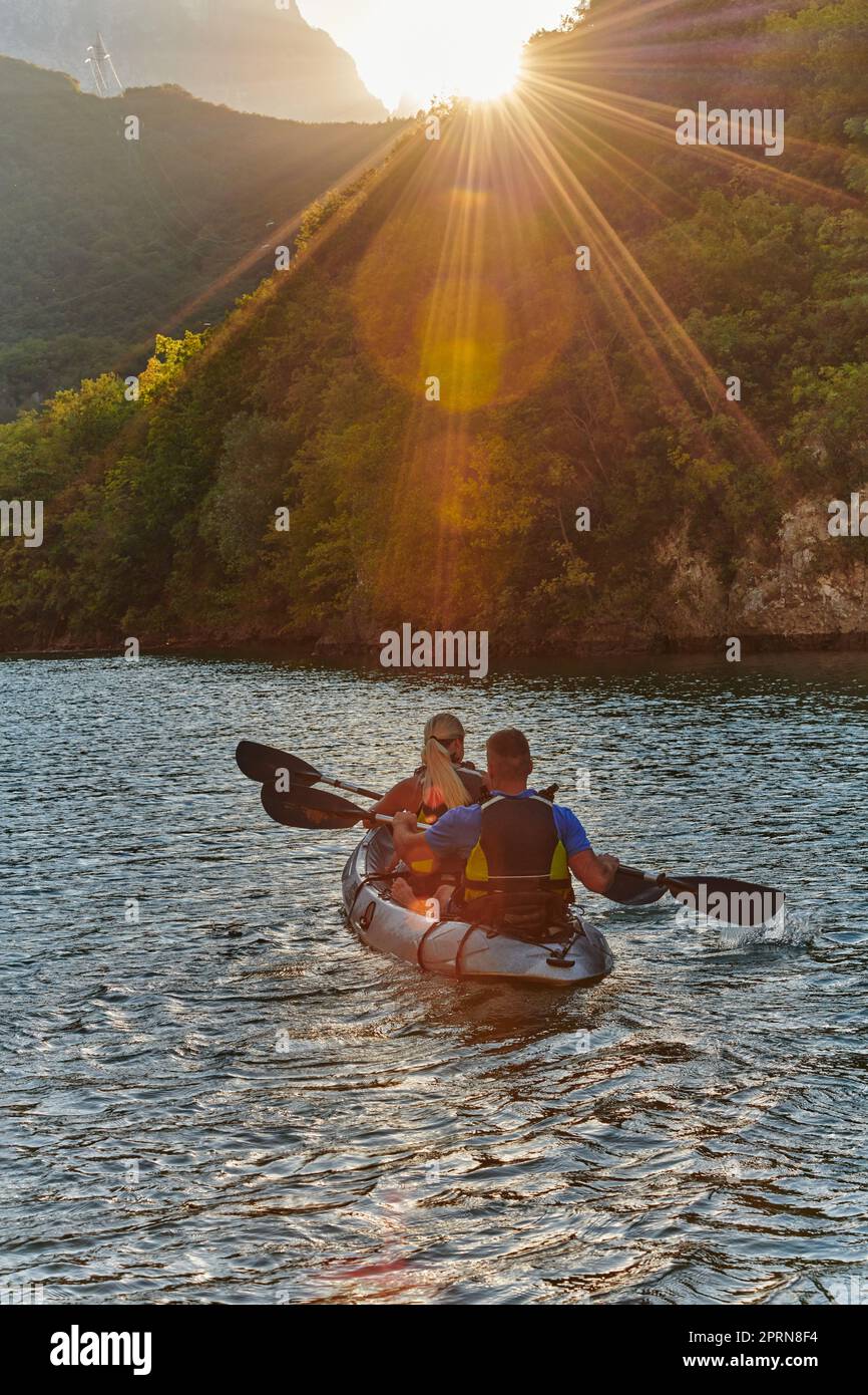 A young couple enjoying an idyllic kayak ride in the middle of a ...