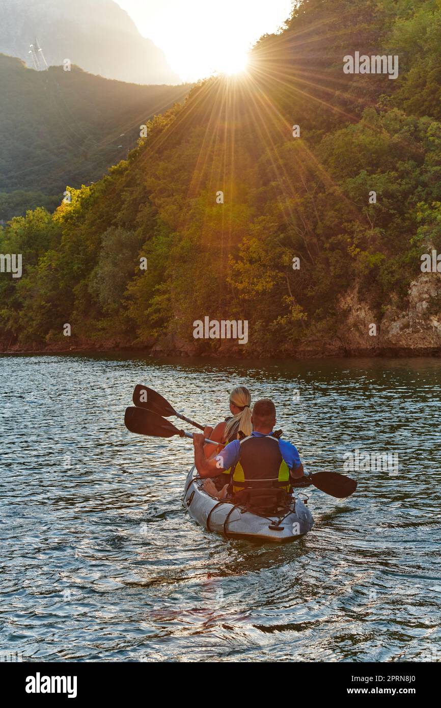 A young couple enjoying an idyllic kayak ride in the middle of a ...