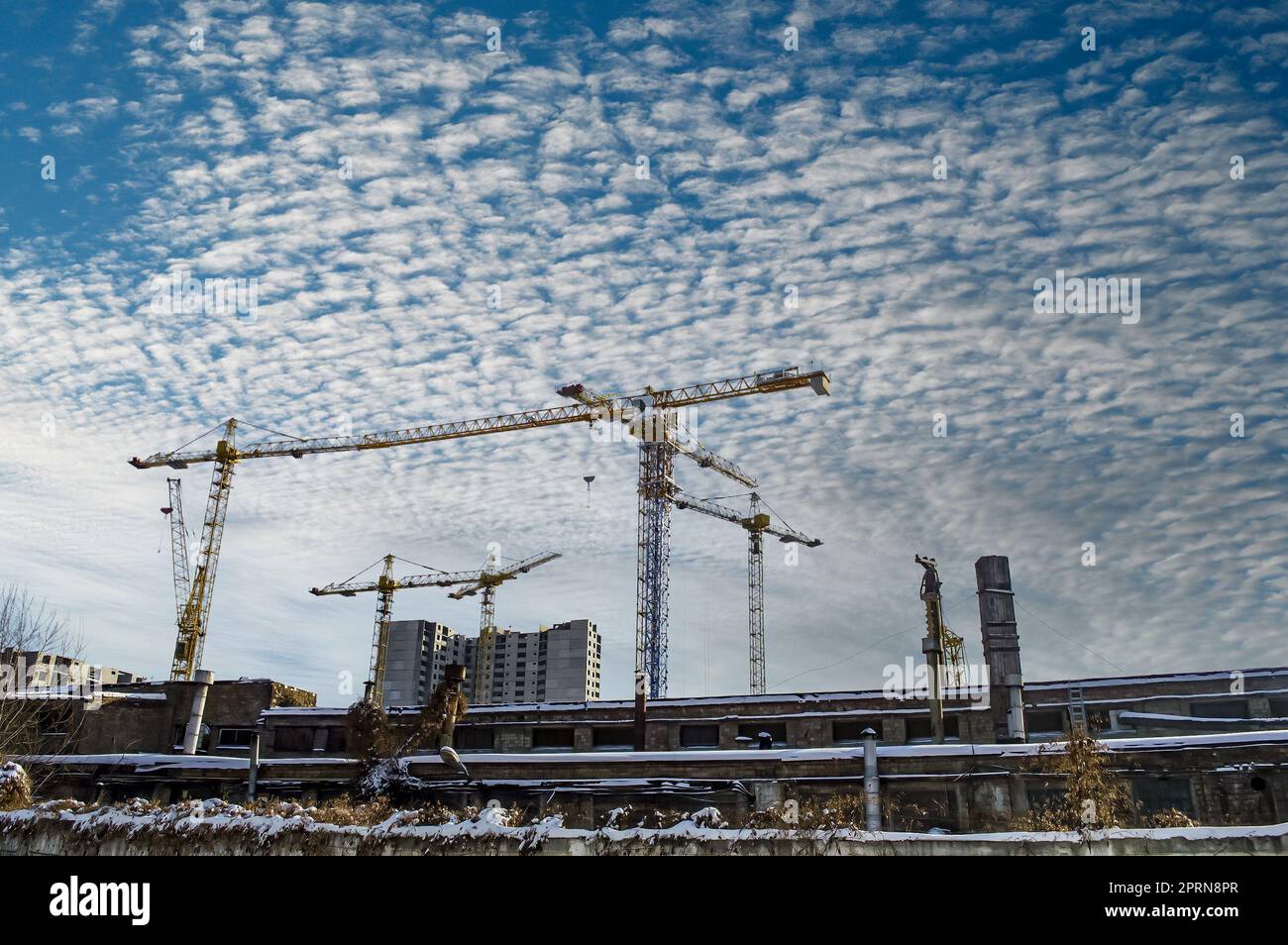 High-rise cranes are building a new house. Construction high-rise crane ...