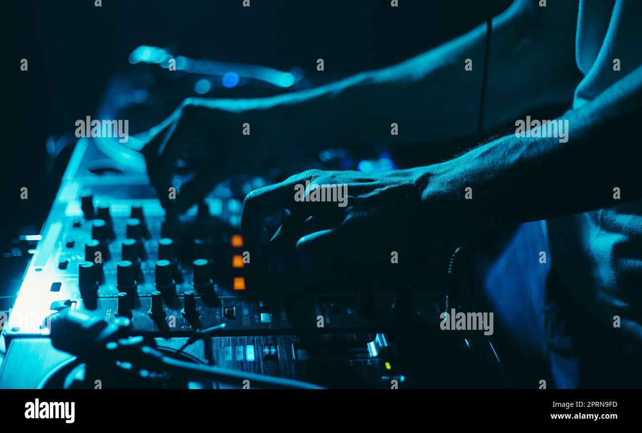 Club DJ playing techno music set on a party. Disc jockey mixing vinyl ...