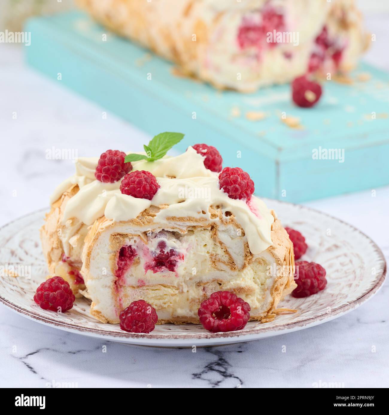 Baked meringue roll with cream and fresh red raspberry, white ...