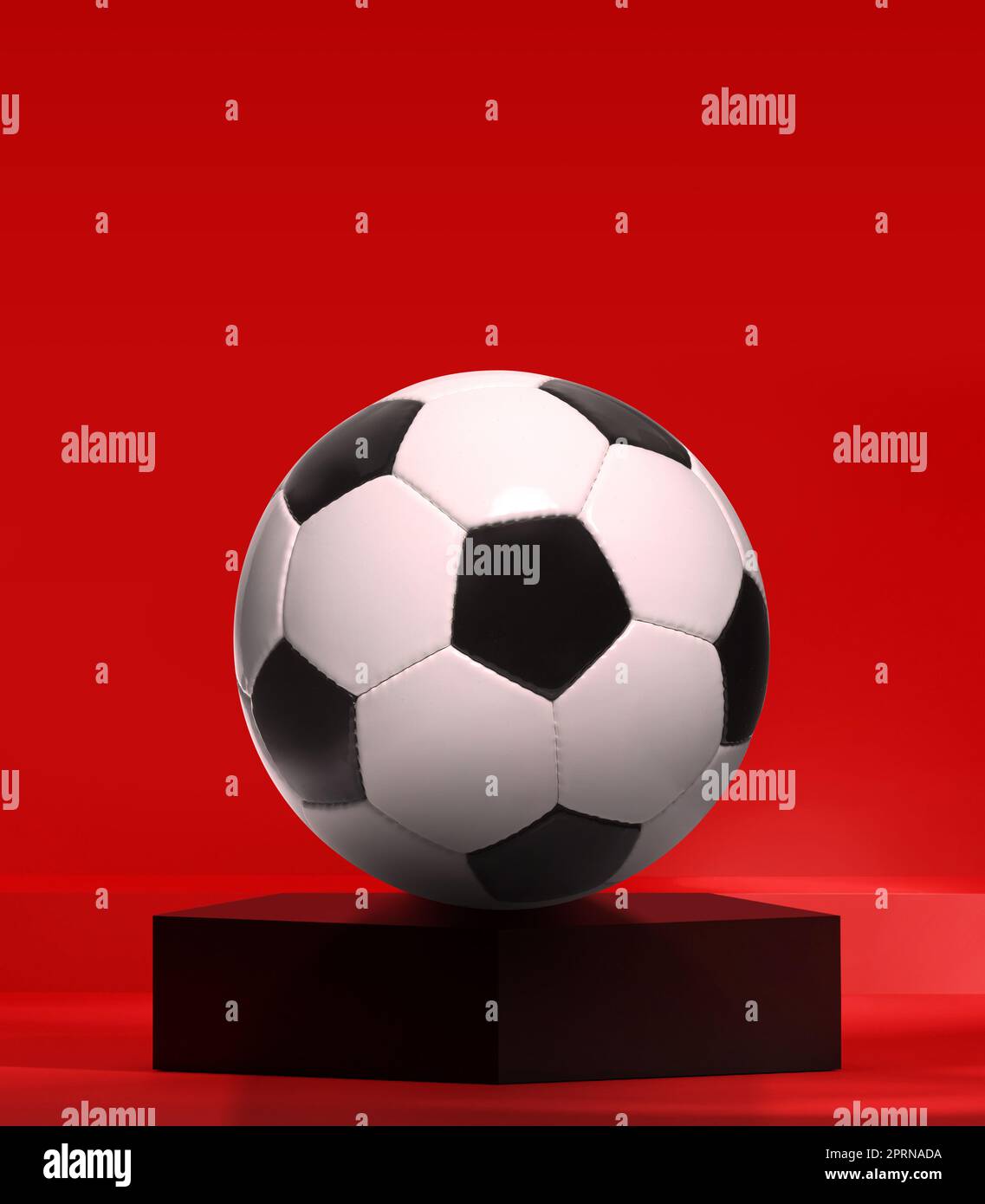 Soccer ball on black pentagon podium in the red studio Stock Photo - Alamy