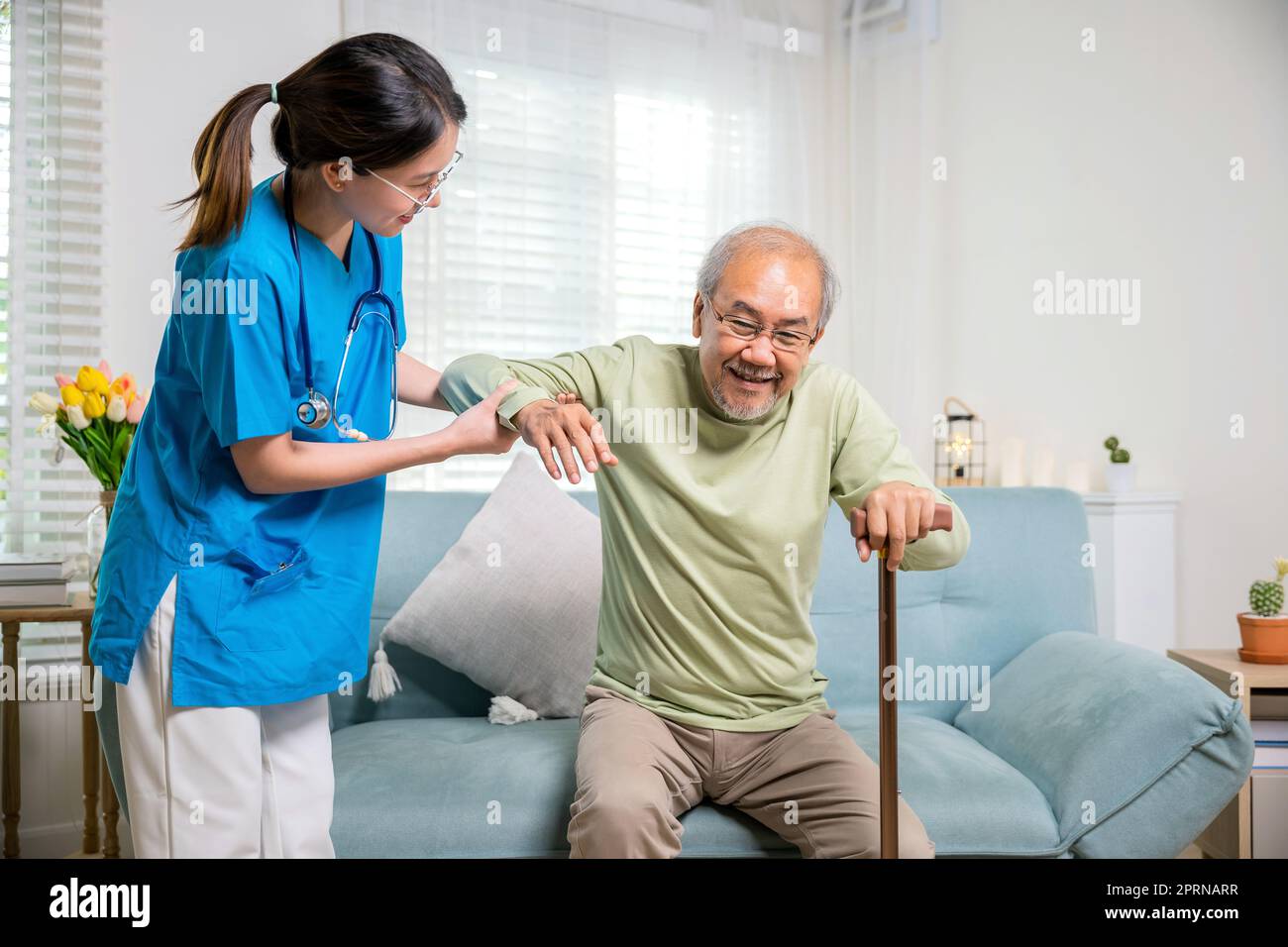 Young woman help support orthopedic patients to get up with walking ...