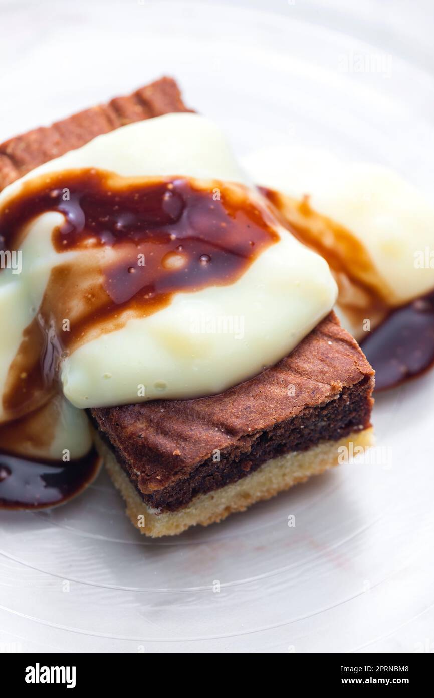 marble sponge cake with creamy custard sauce Stock Photo - Alamy