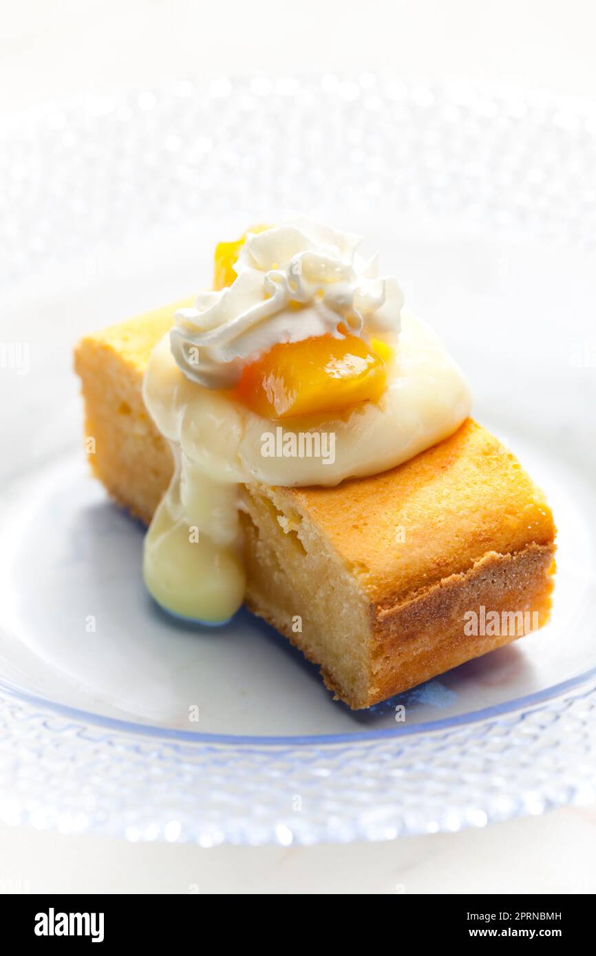 sponge cake with vanilla custard, peach and whipped cream Stock Photo ...
