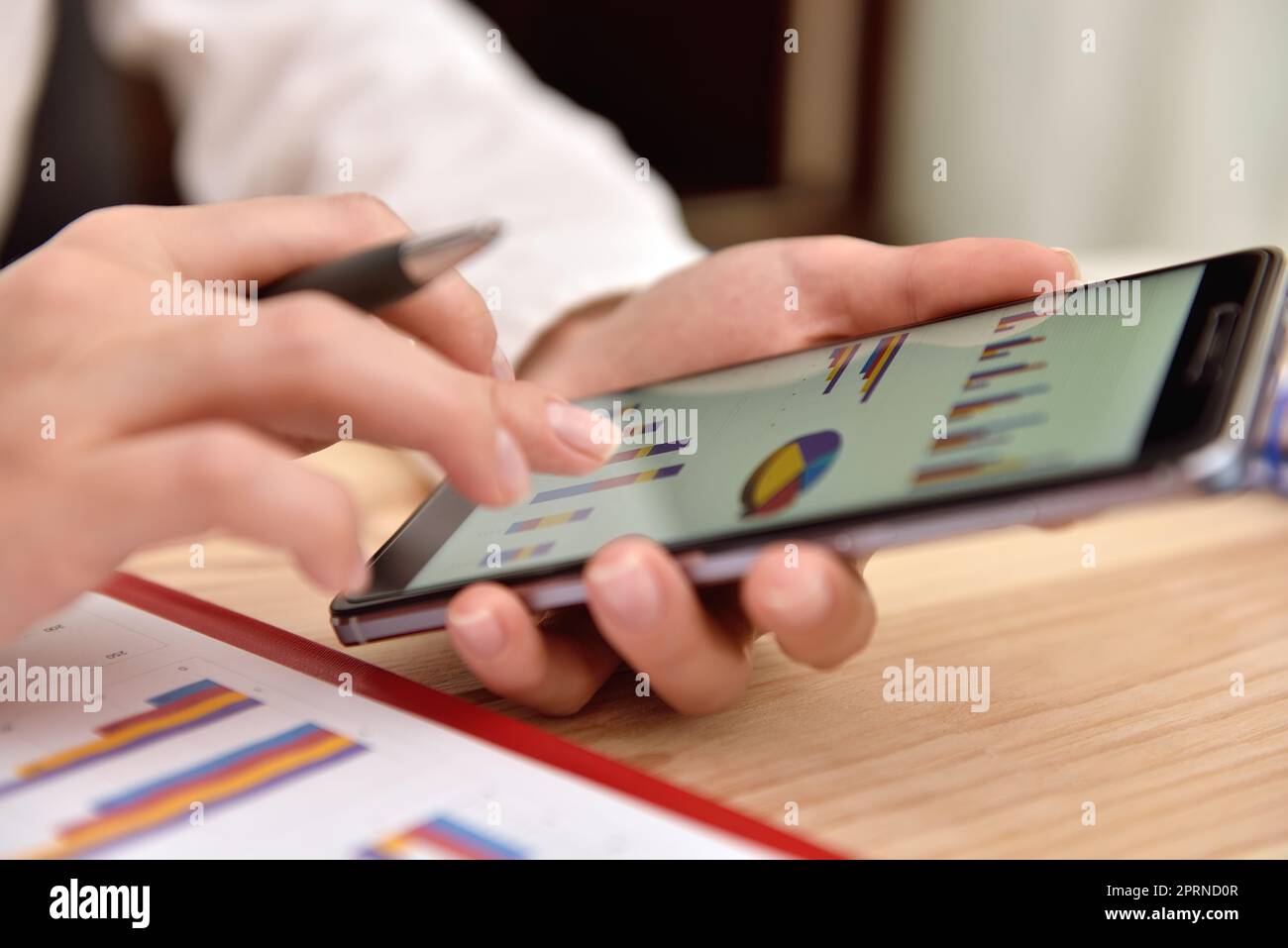 Smart phone with financial data in form of charts and diagrams ...