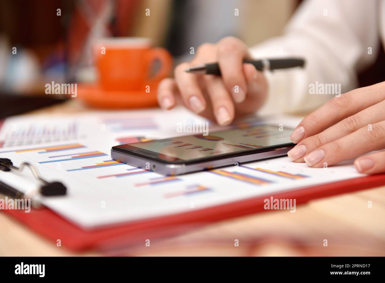 Trader woman hand analyzing income data on mobile phone screen. Close ...