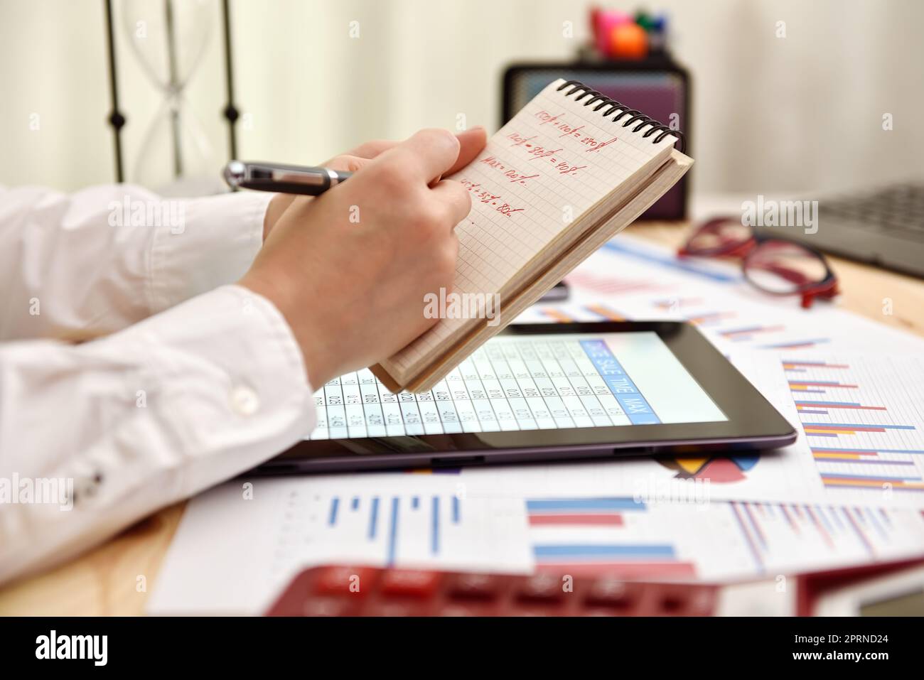 Hand records in a notebook Financial Report and stock data. Close Up ...