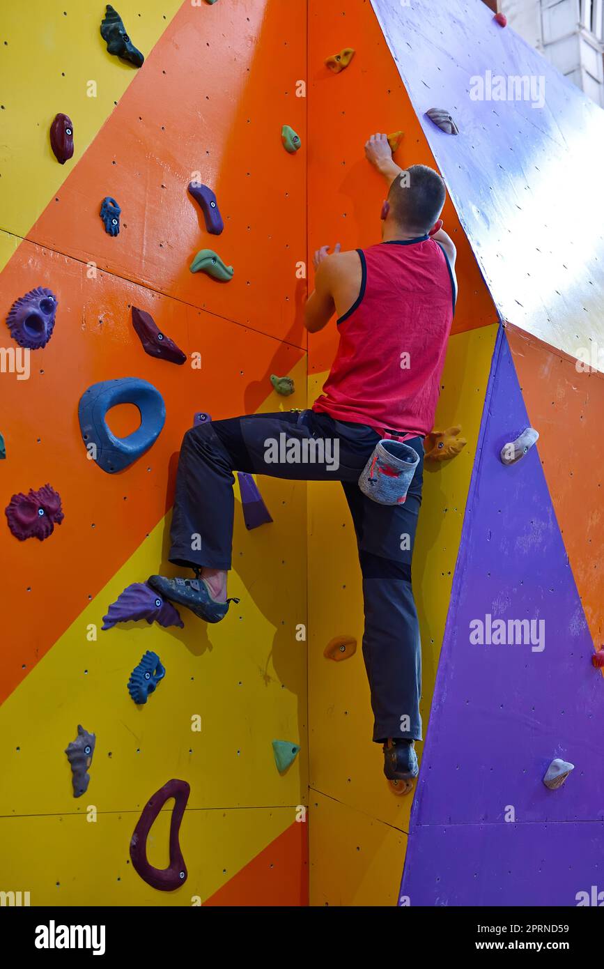 Athletic Climber Man Climbing On Practice Wall Indoors. View From Back ...