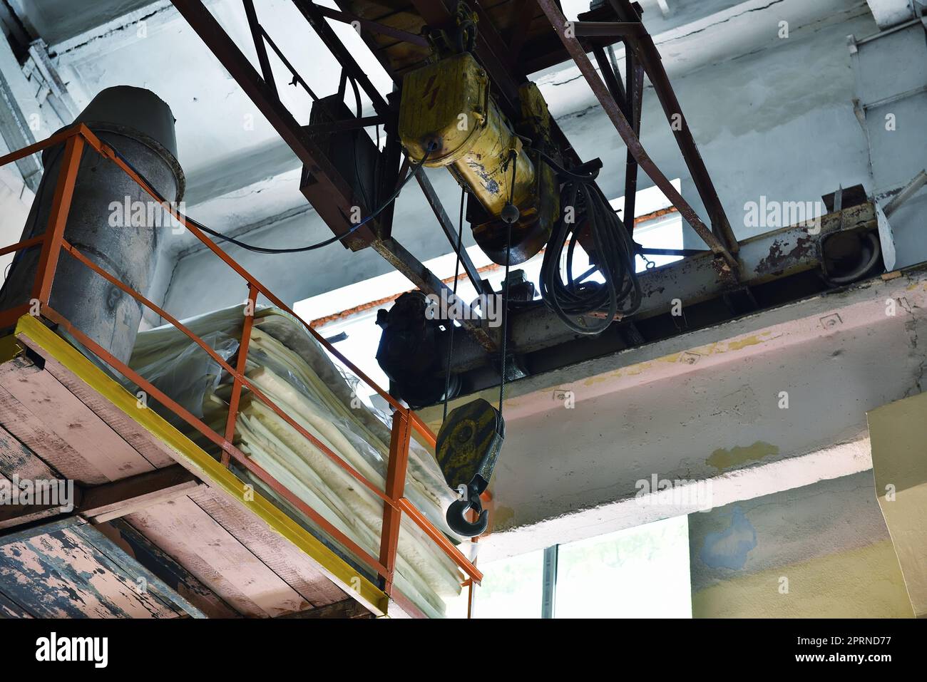 Industrial crane hook in a building interior Stock Photo - Alamy