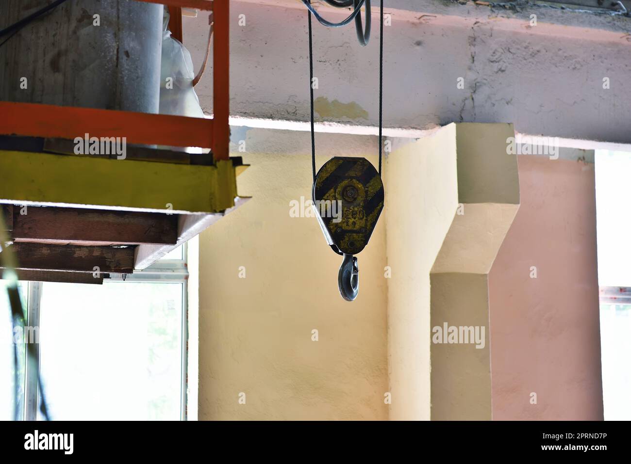 Industrial crane hook in a building interior. close up Stock Photo - Alamy