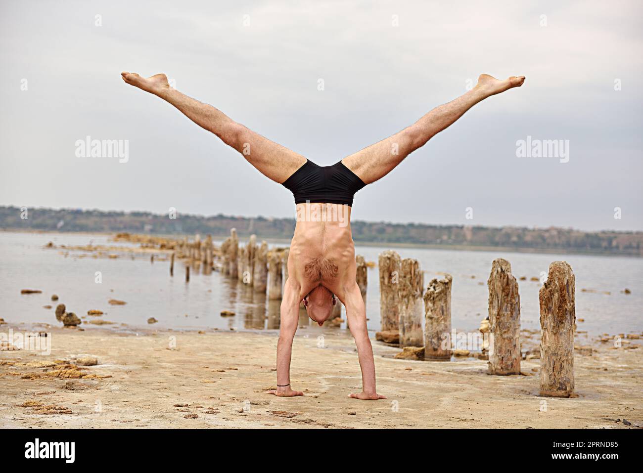 yoga man standing on hands and does the splits Stock Photo - Alamy