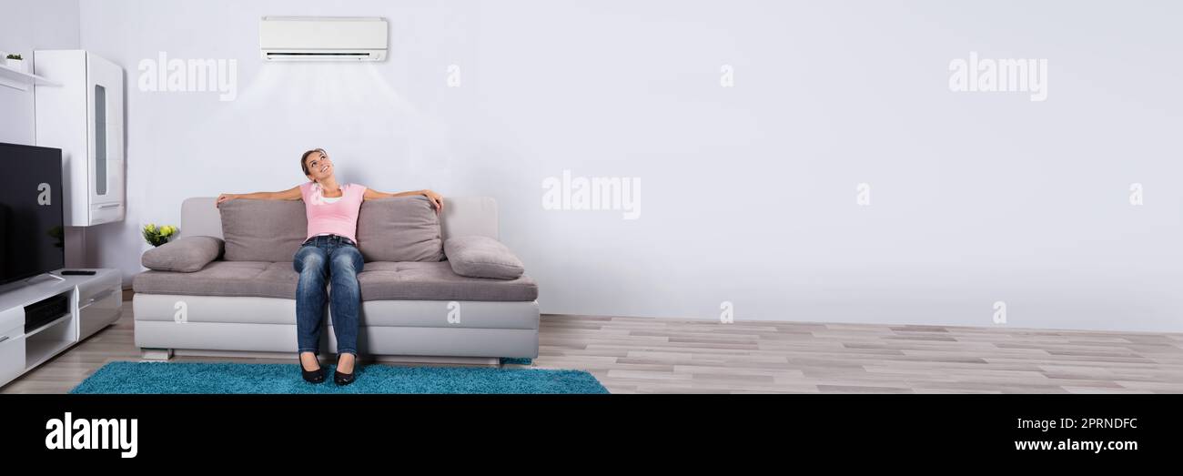Air Conditioner At Home. Happy Woman Relaxing With AC Stock Photo - Alamy