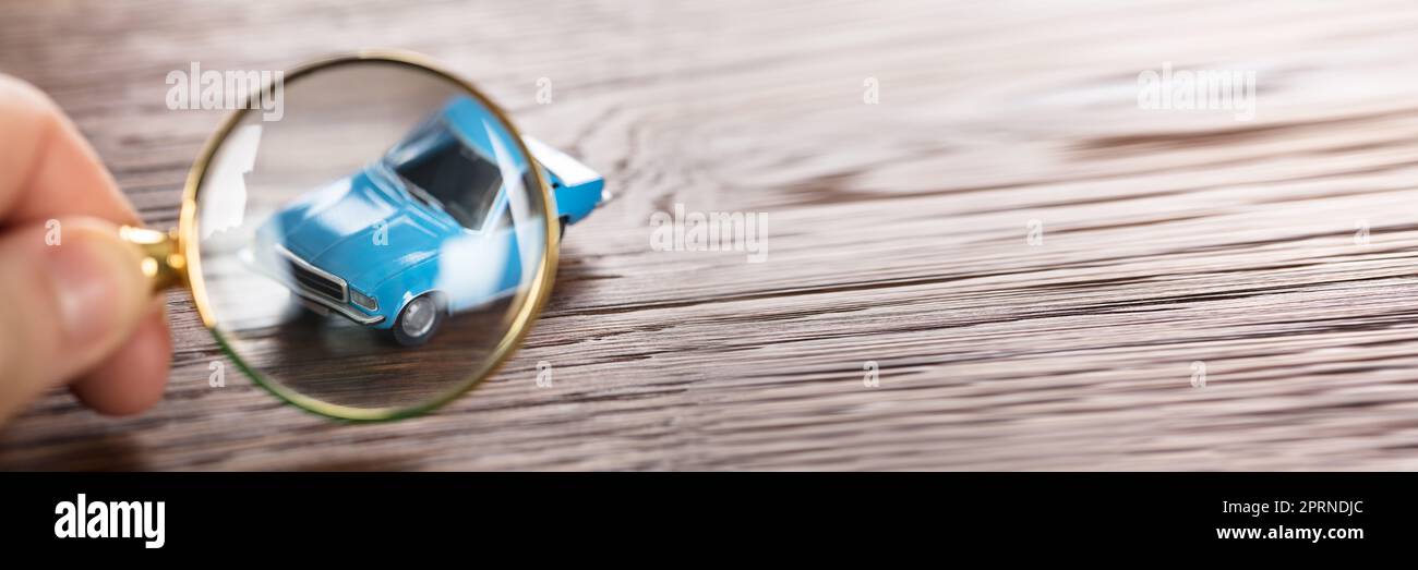 Car Check Using Magnifying Glass. Vehicle Research Stock Photo - Alamy
