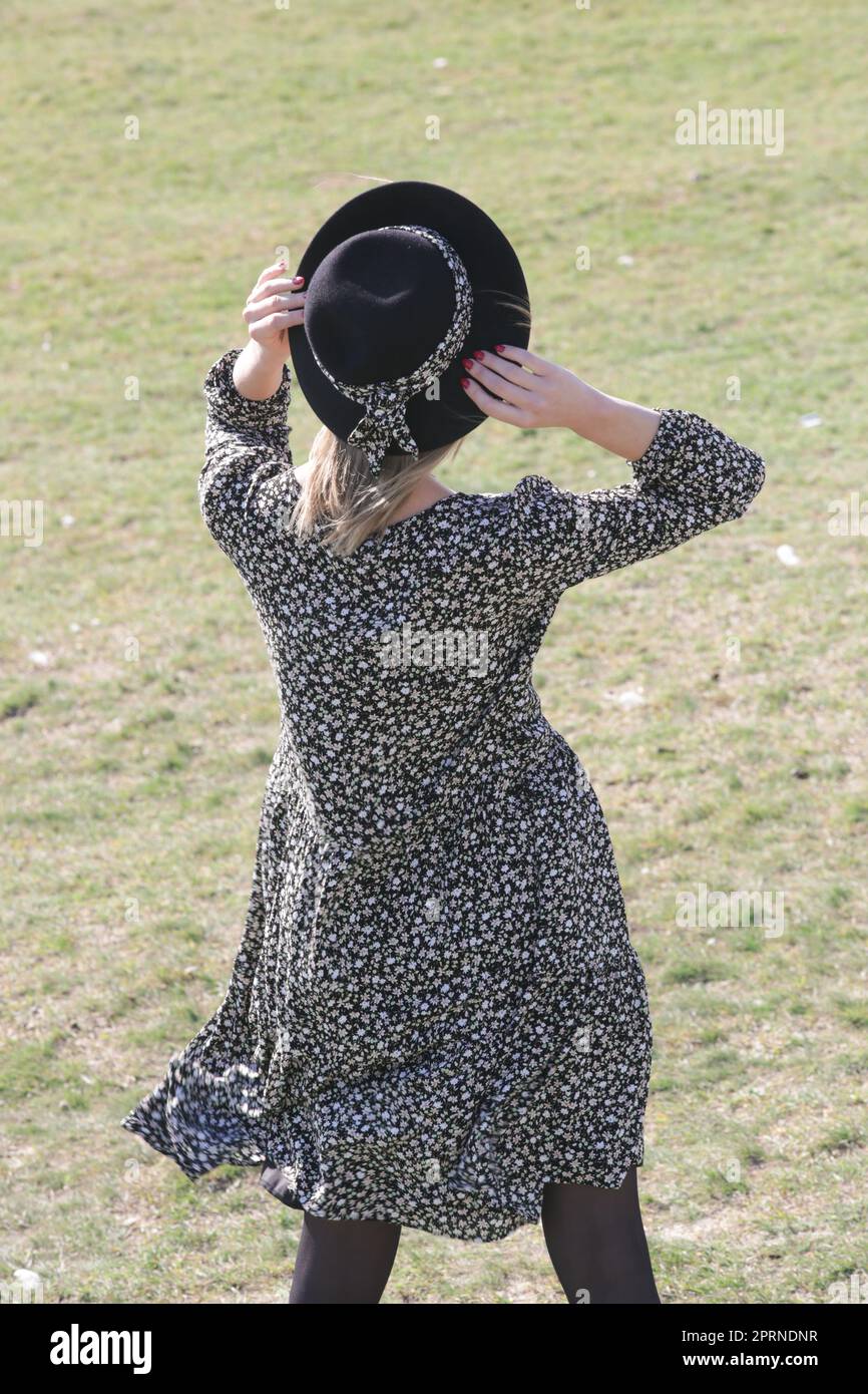 Outdoor fashion portrait of female model in flowy boho floral dress and ...