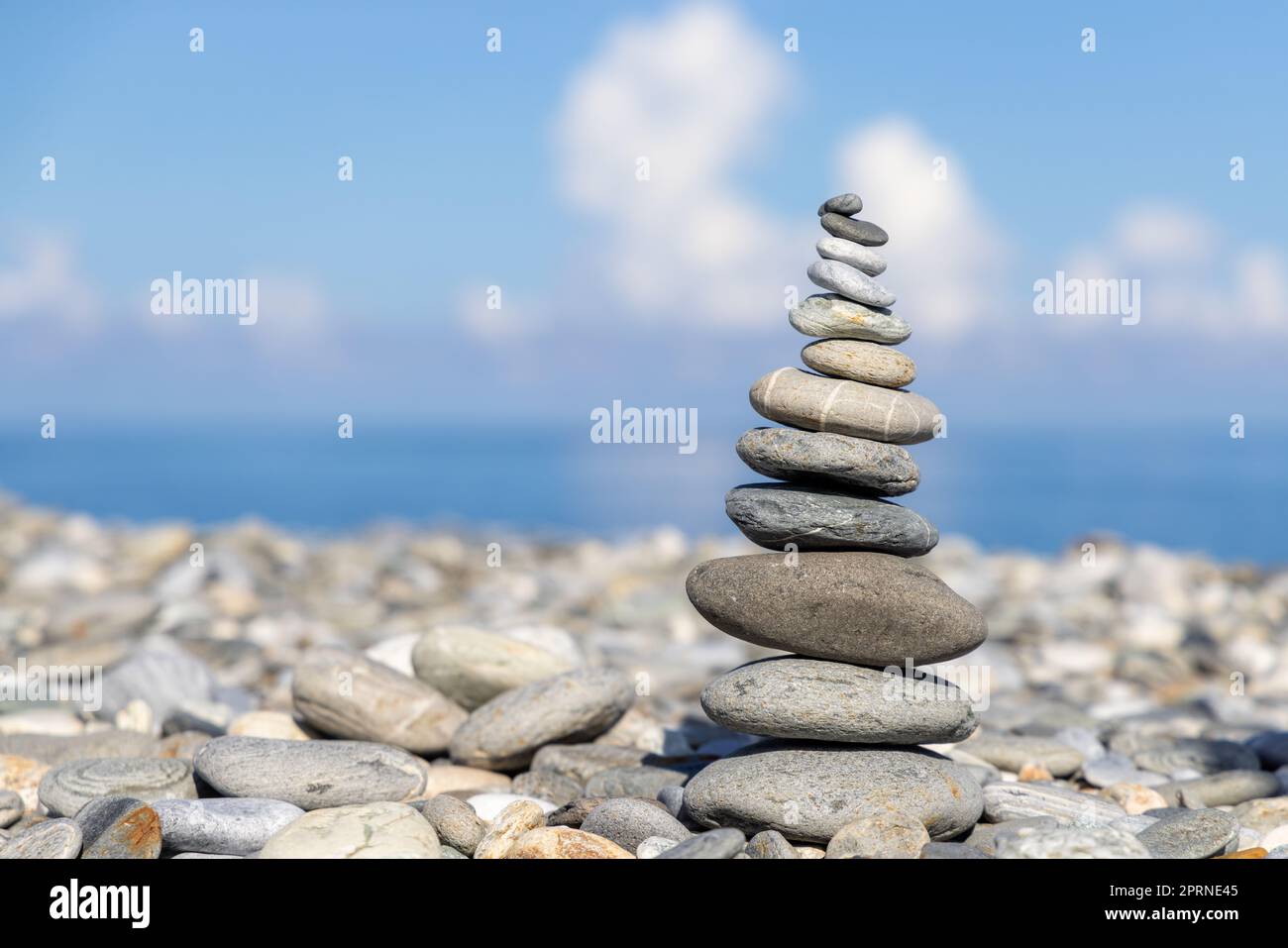 Pebble tower balance harmony stones arrangement on sea beach coastline ...