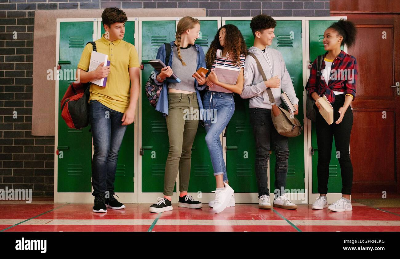 Killing some time before class. a group of cheerful young school kids ...