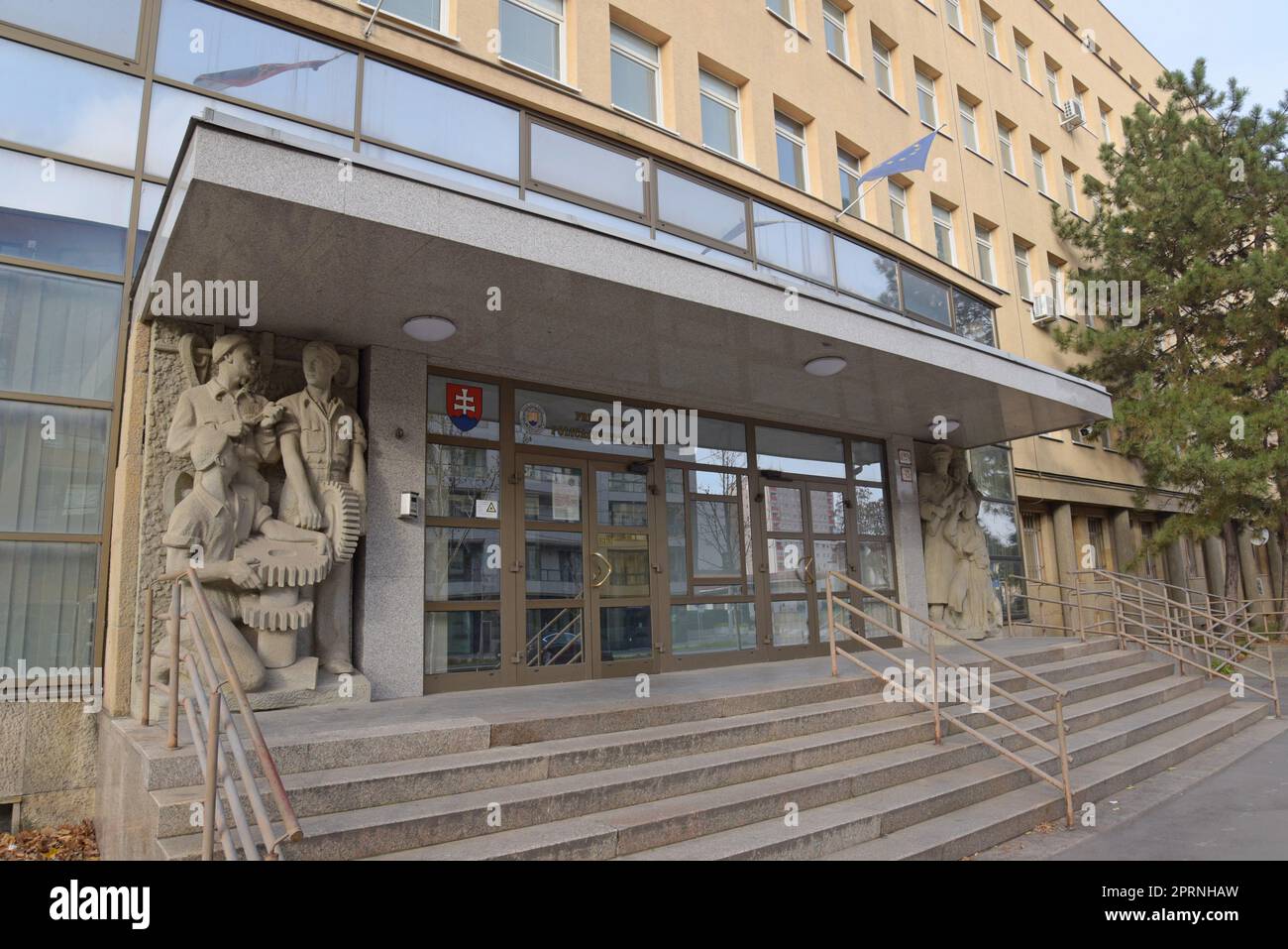Communist era stone sculptures either side of the entrance doors of the ...