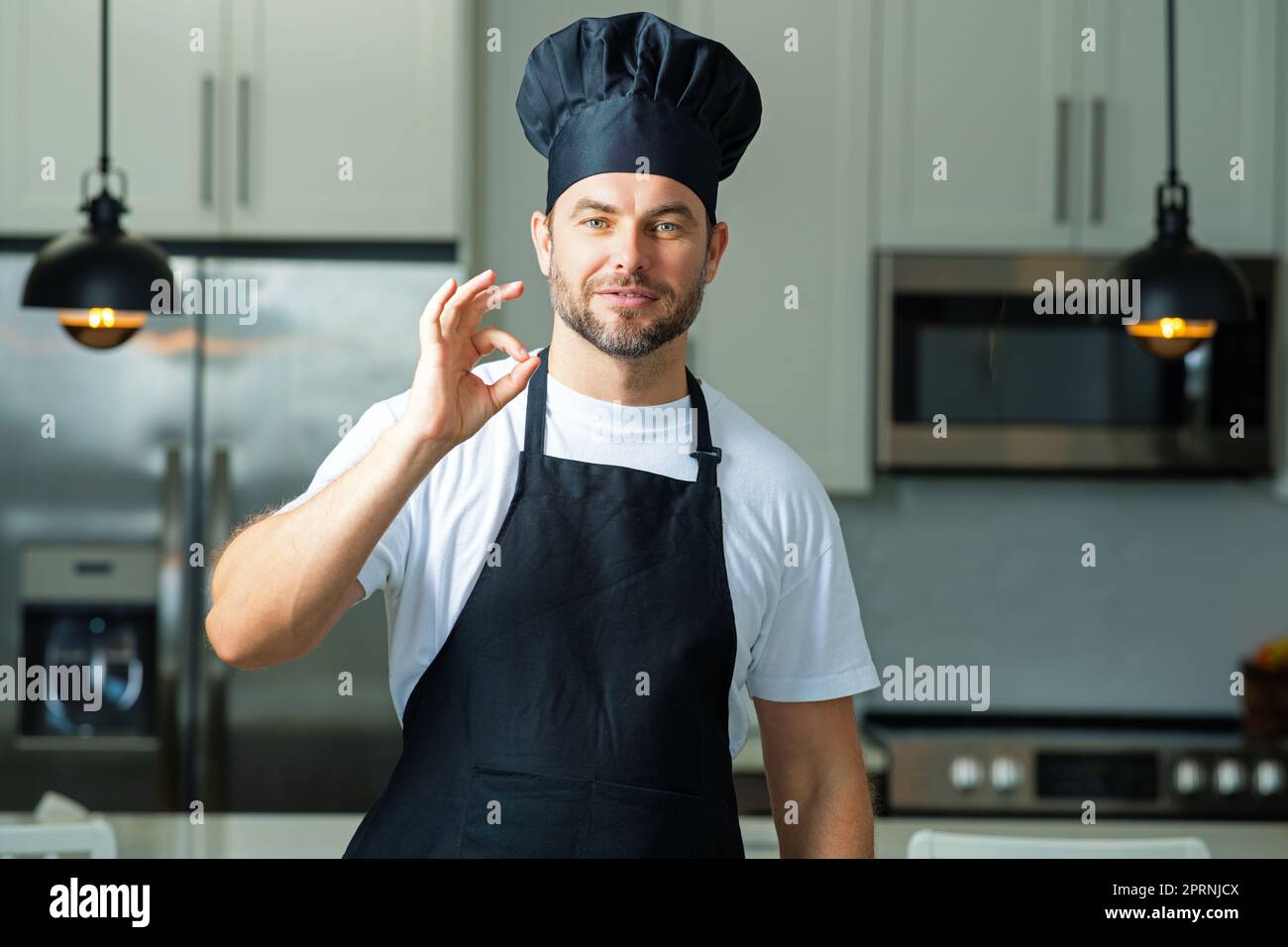 Chef on kitchen. Professional chef man in uniform on kitchen.Chef cook ...