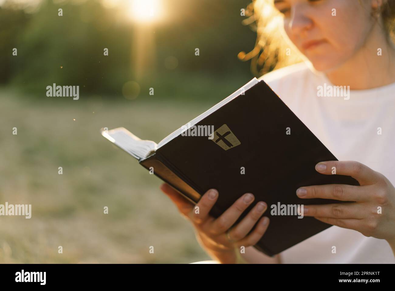 Christian woman holds bible in her hands. Reading the Holy Bible in a ...