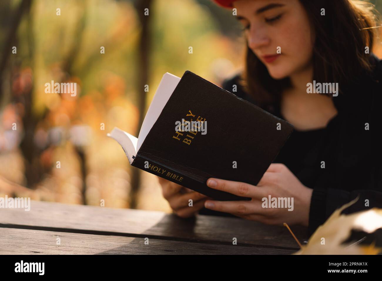 Christian teen girl holds bible in her hands. Reading the Holy Bible ...