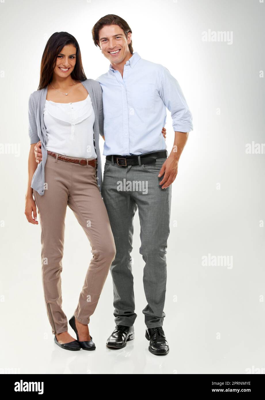 Perfect partners. Portrait of a multi-ethnic couple standing isolated ...