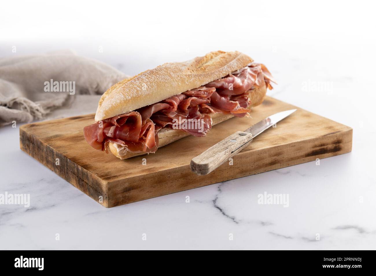 Spanish serrano ham sandwich on marble background Stock Photo - Alamy