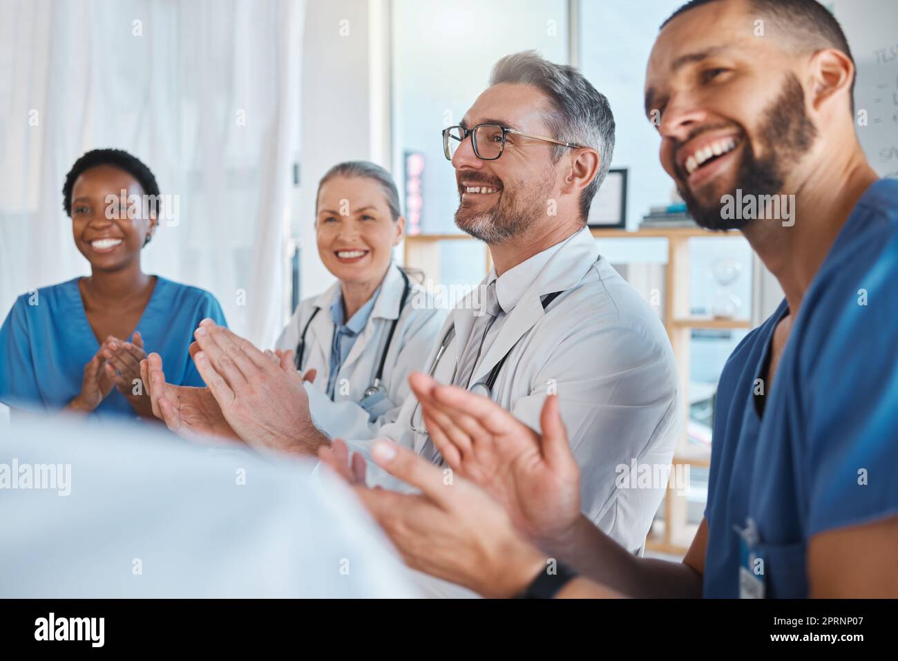 Doctors, nurses and teamwork collaboration clapping after medical presentation, healthcare ...