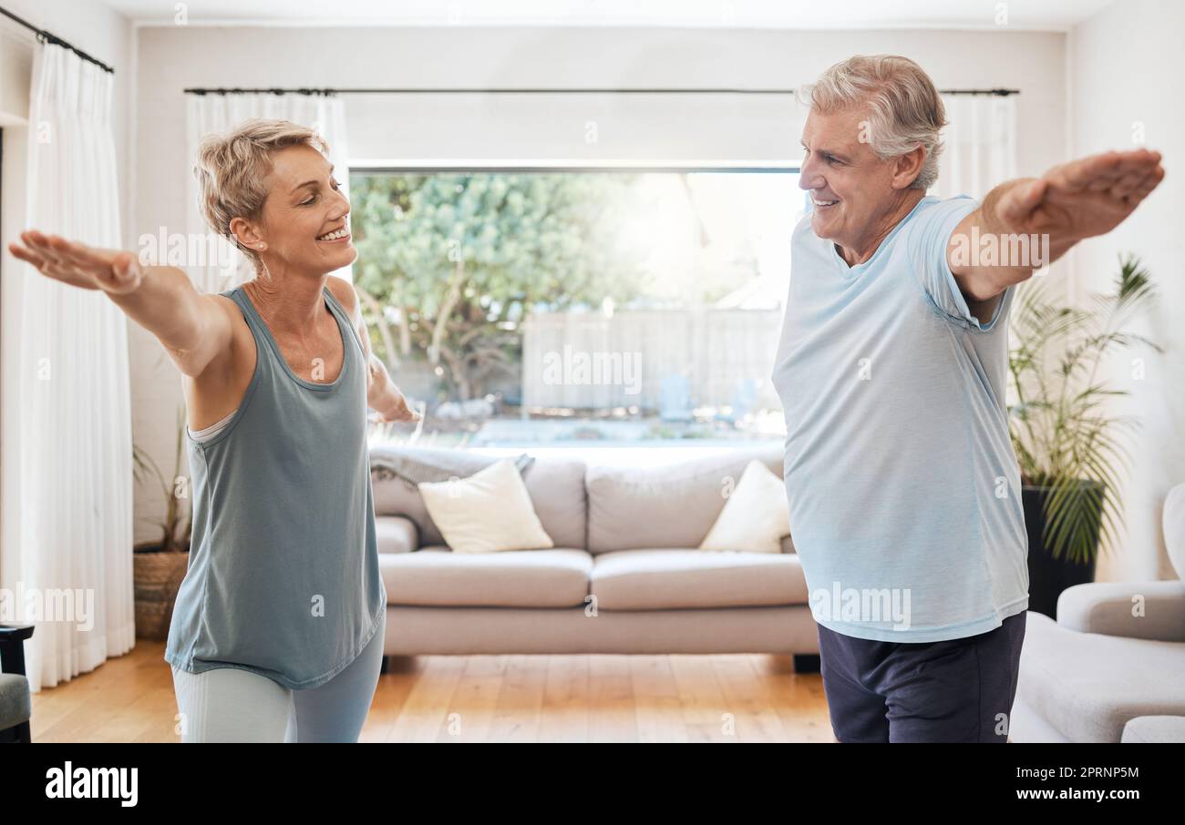 Yoga wellness in home, senior couple stretching muscles in living room ...