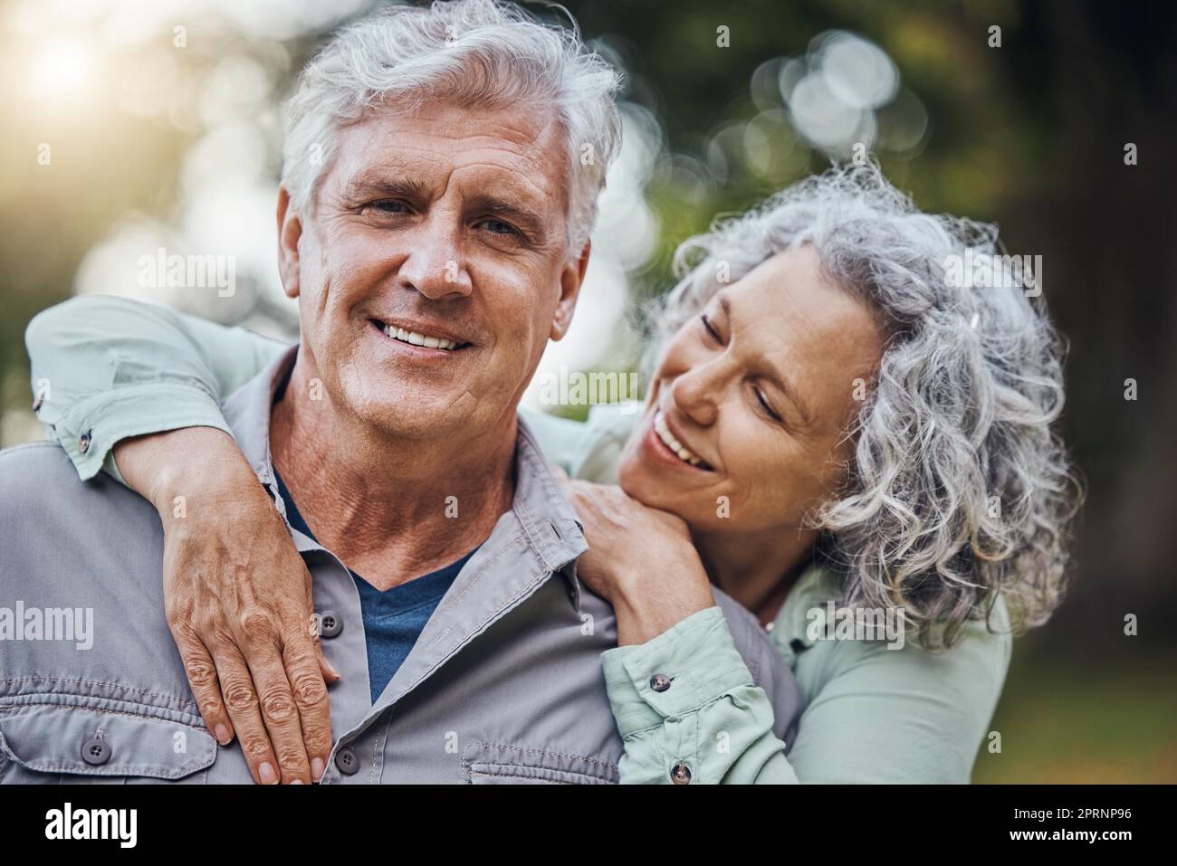 Senior hug, couple and marriage love in nature with a happy smile of ...