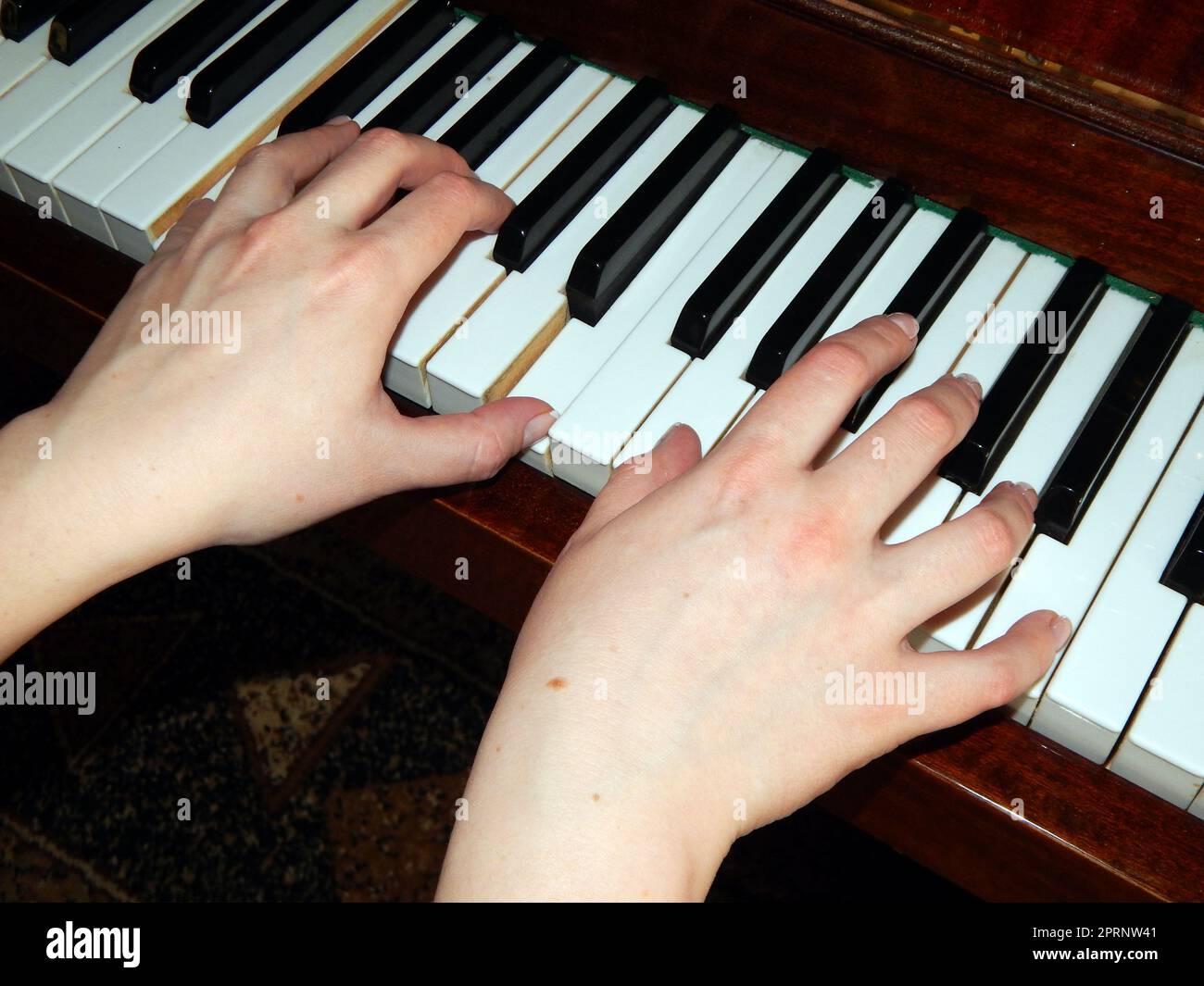 Piano keys hand Stock Photo - Alamy