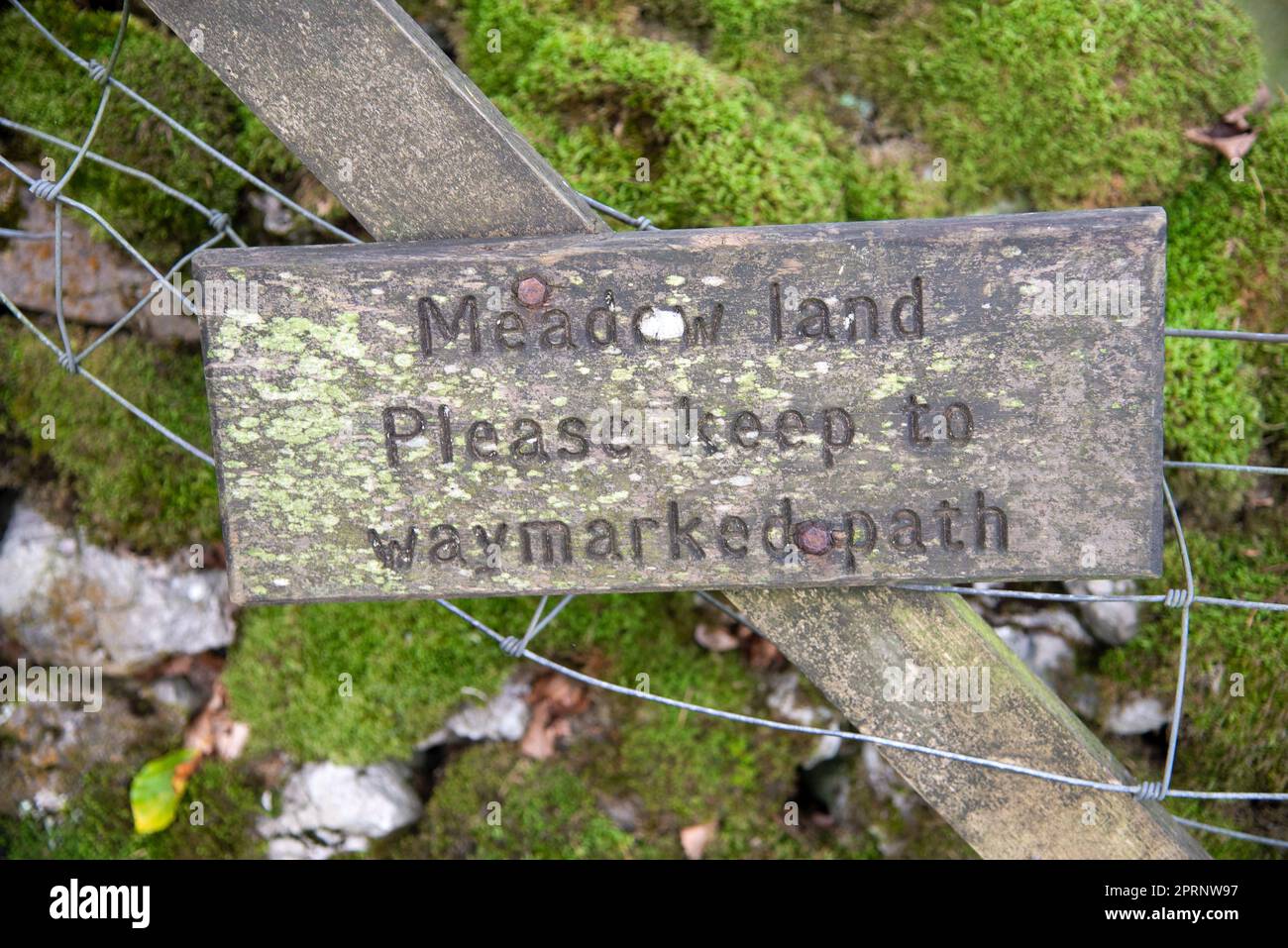 Wooden sign "Please keep to the waymarked path" in the Deepdale in the ...