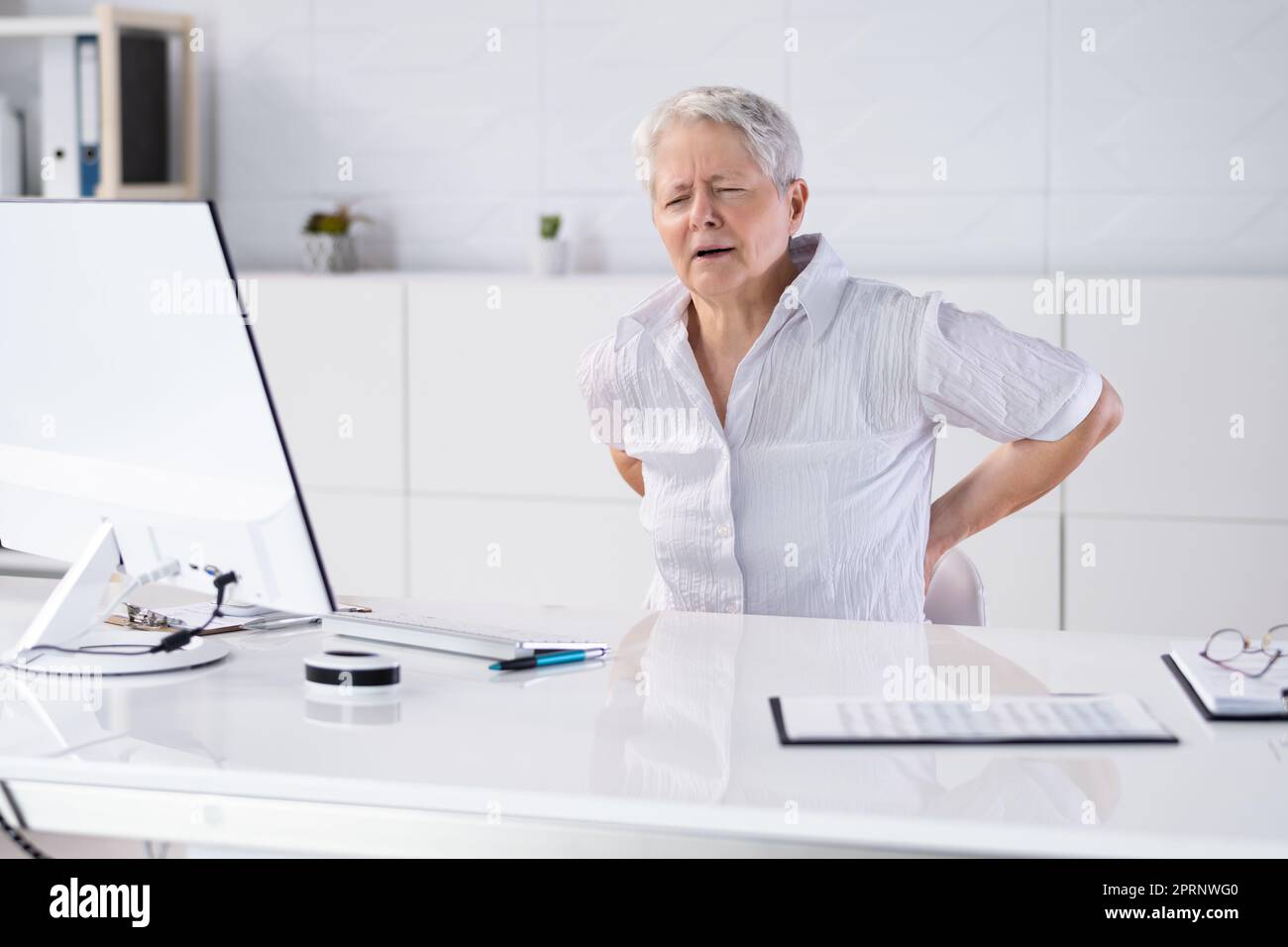 Woman With Back Pain Stock Photo - Alamy
