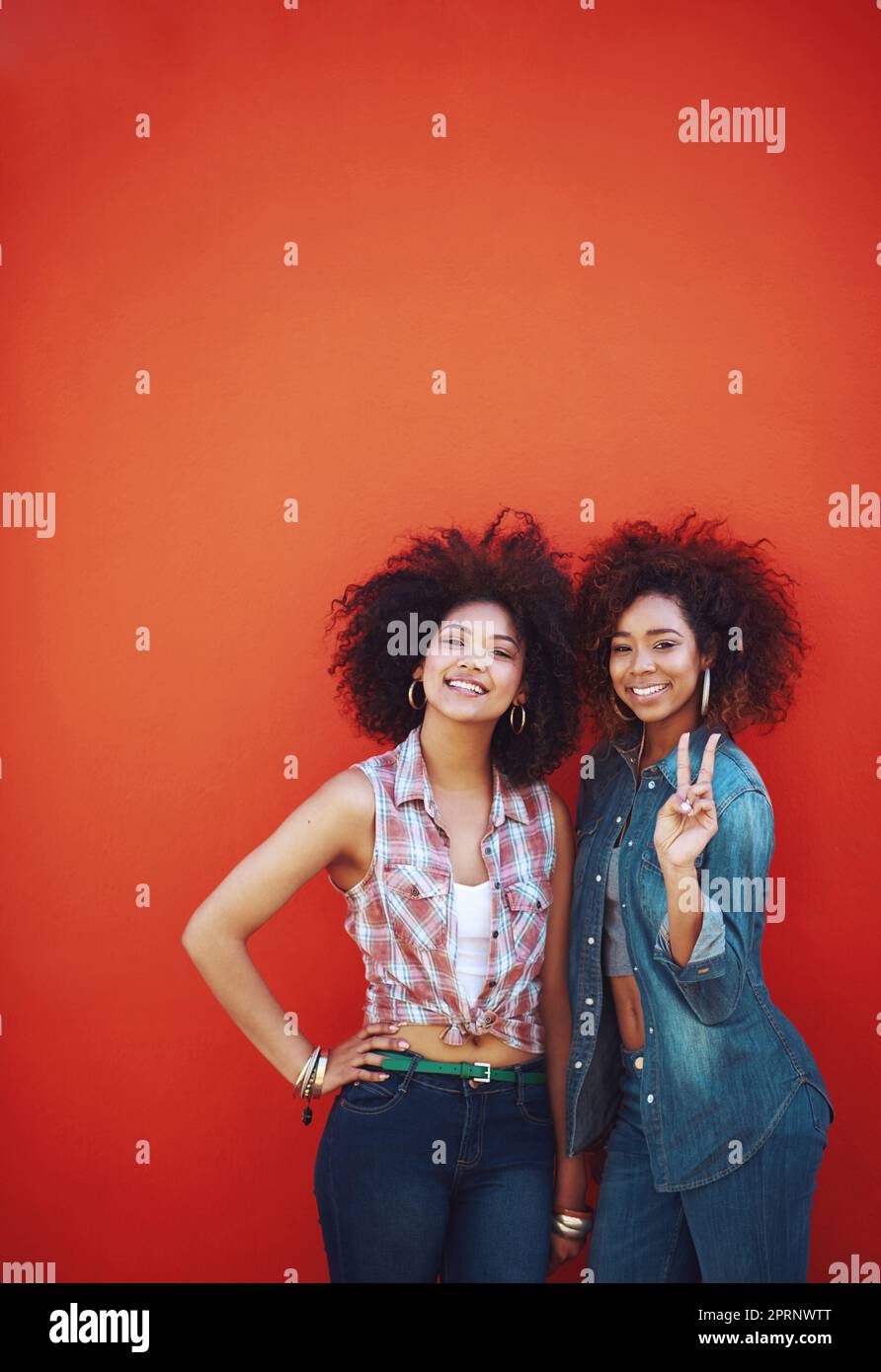 My besties the best ever. two young friends posing against a red ...