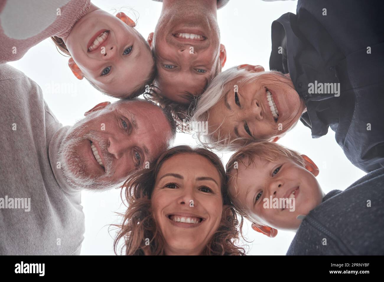 Happy family in a group huddle hi-res stock photography and images - Alamy