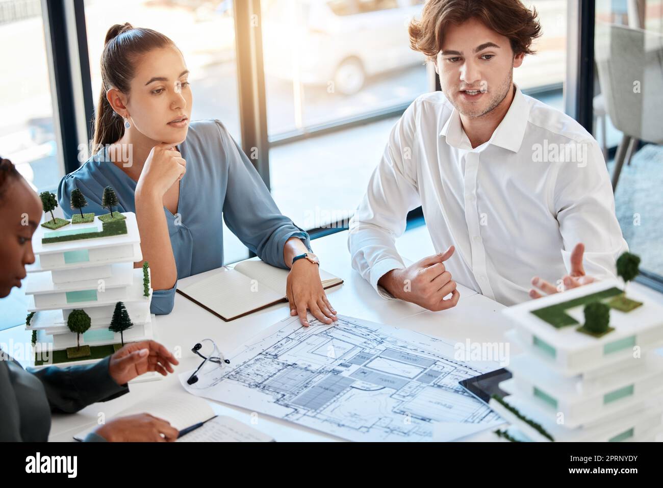 Team, architect engineer and planning building 3d model in meeting with logistics, diversity and ...