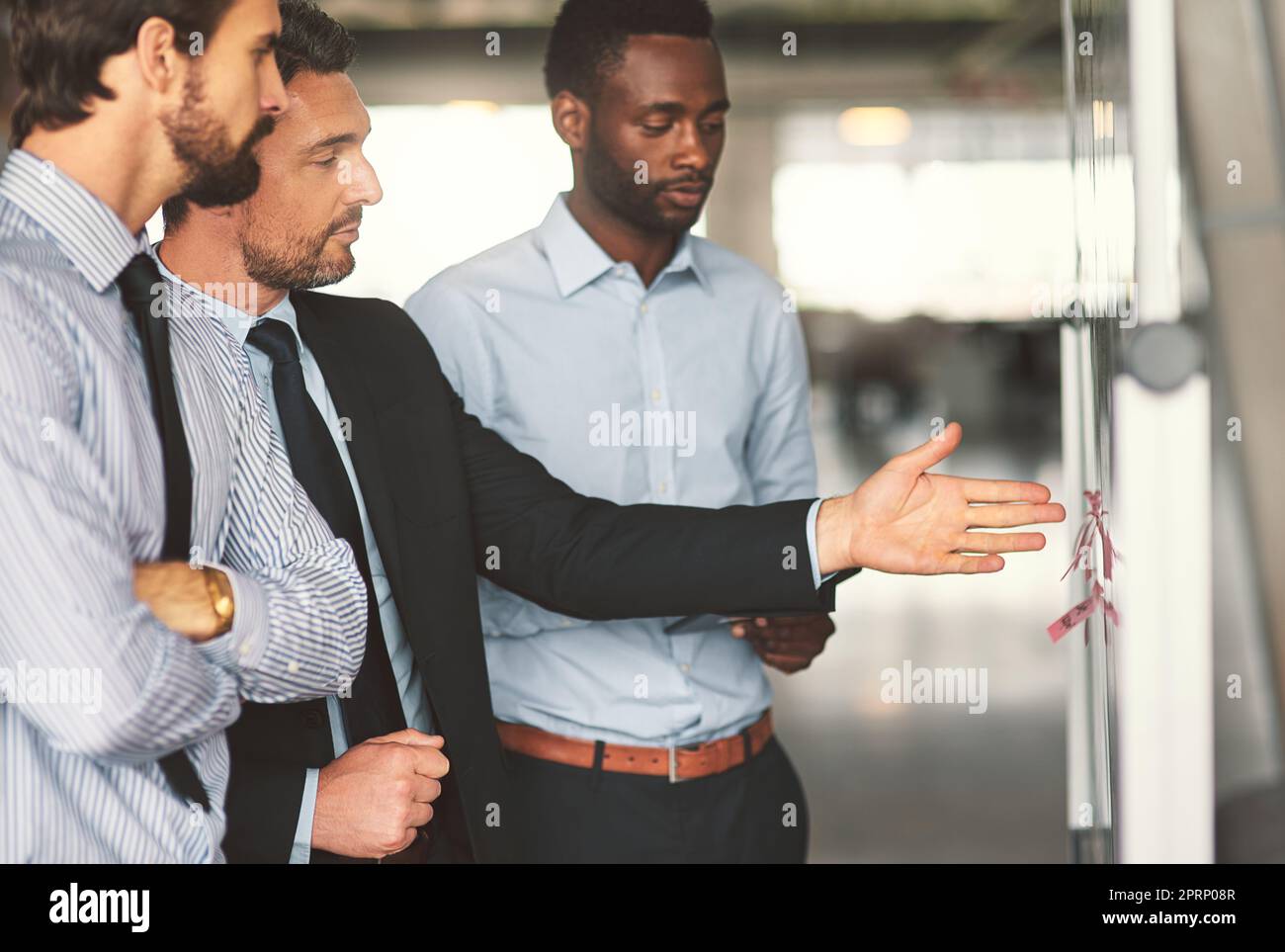 Planning out a course of company action. young businesspeople ...