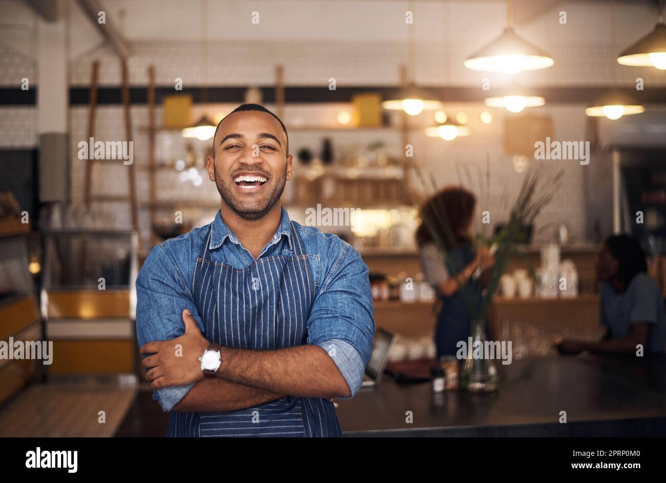 Service done right. handsome young businessman standing with his arms ...