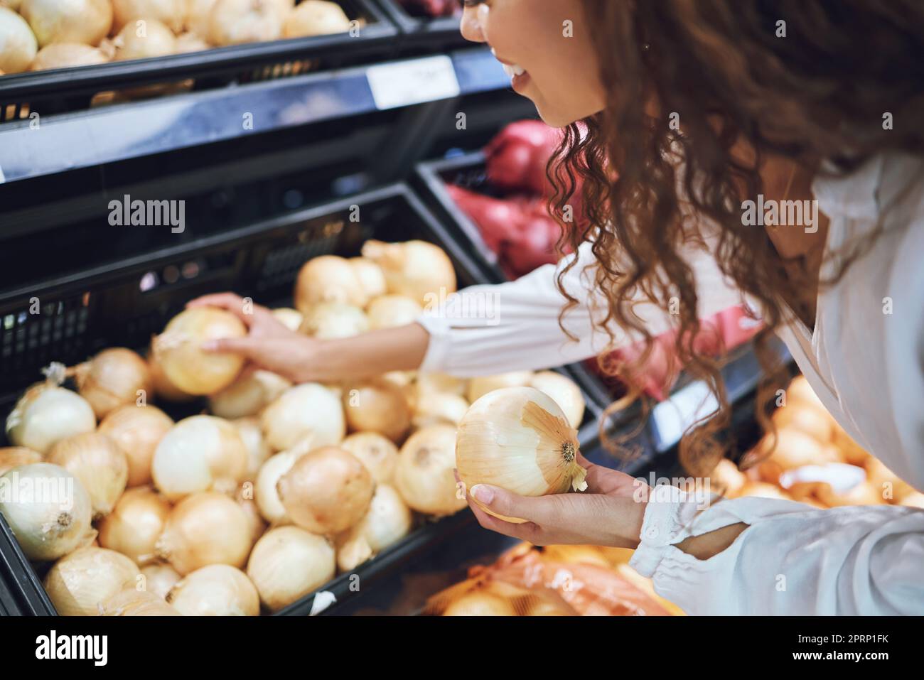 Supermarket, onion and customer shopping for healthy food, cooking and ...