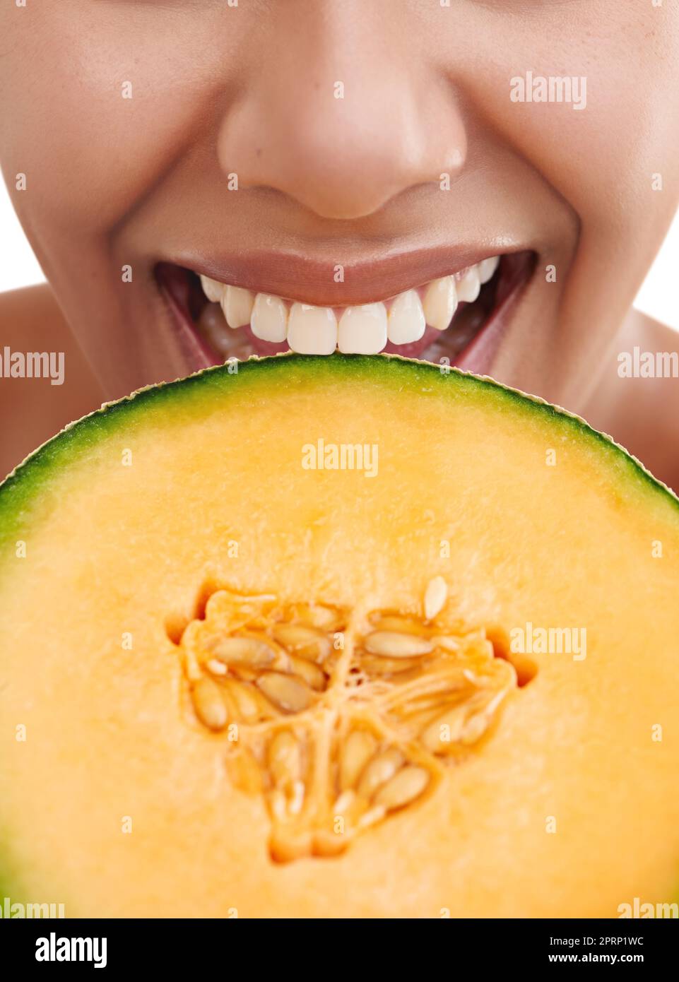 Delicious and good for you. Cropped studio shot of a young woman biting ... Delicious and good for you. Cropped studio shot of a young woman biting ...