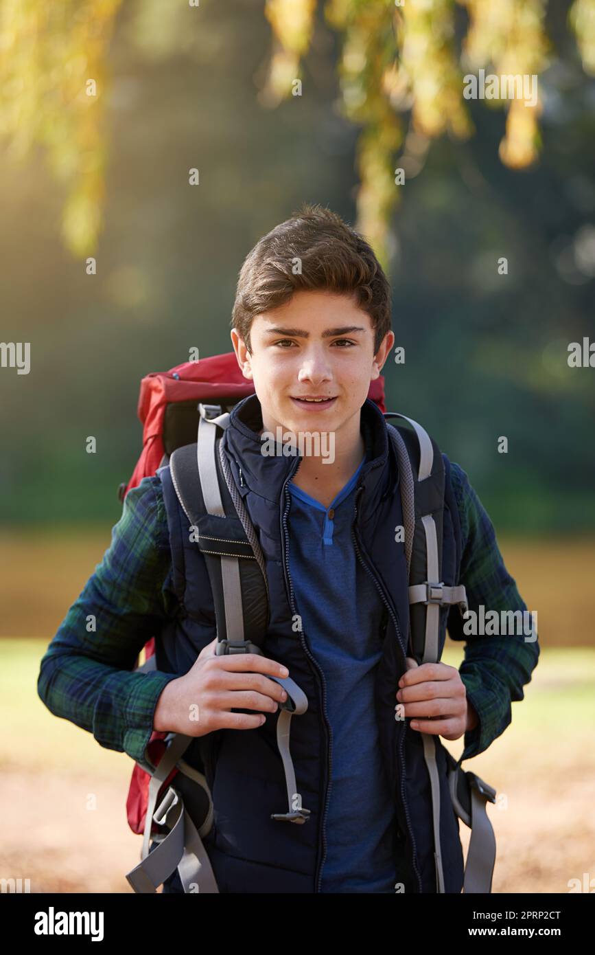 Hes ready for an adventure. Portrait of a young boy wearing a backpack ...