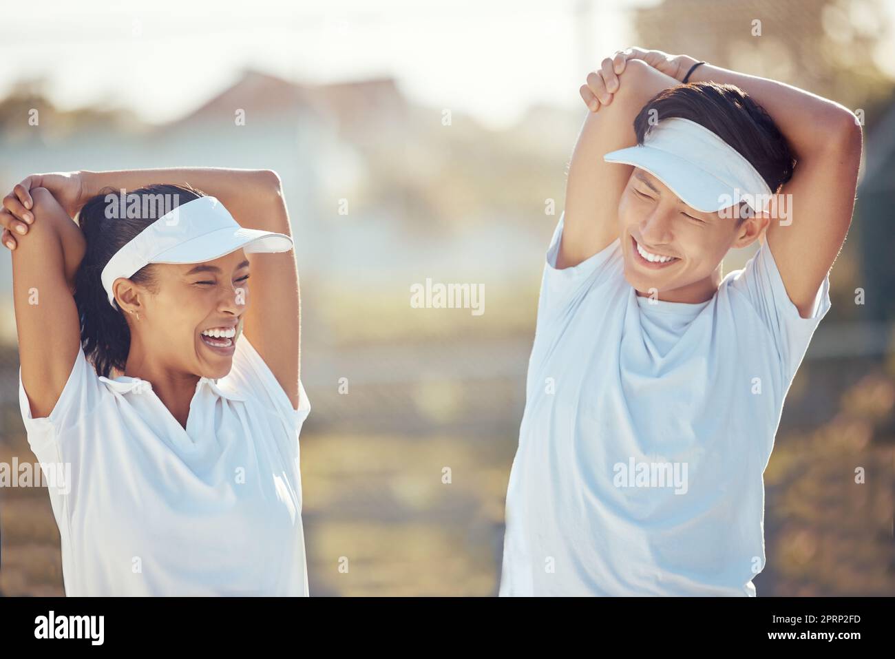 Tennis players stretching arms for a warm up exercise for the joints or ...